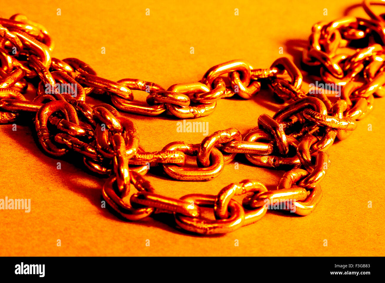 iron chain on brown background Stock Photo - Alamy