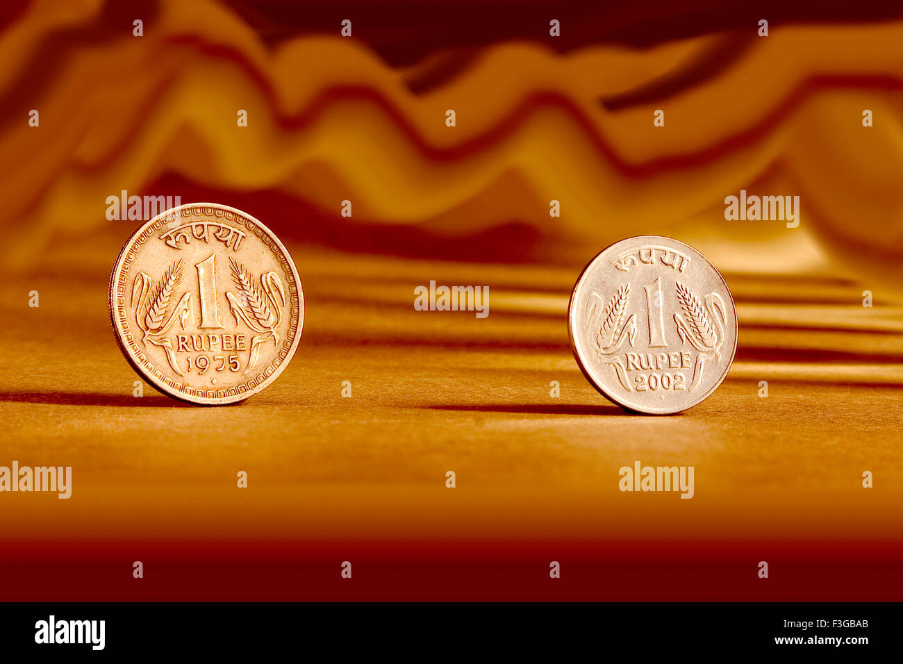 Double pair Indian currency one rupees coin and artistic background ...