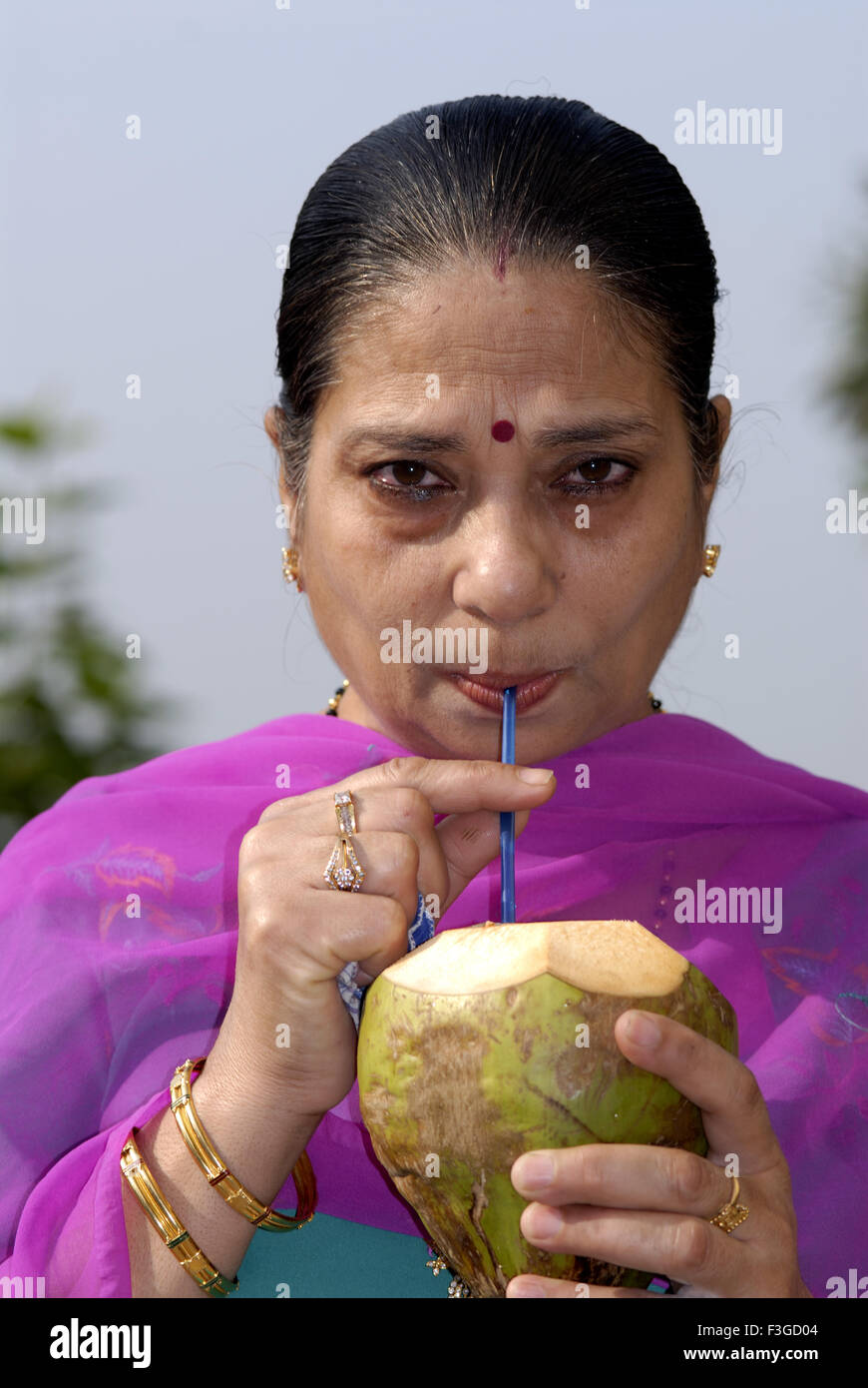 Woman drinking coconut water MR Stock Photo - Alamy
