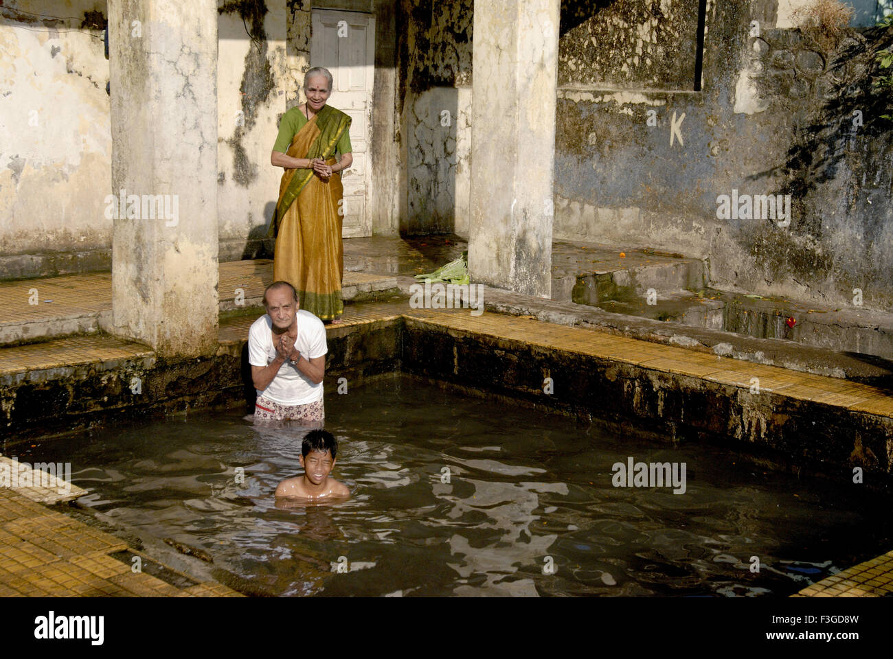 Old couple enjoying holy dip in hot spring water at Ganeshpuri near ...