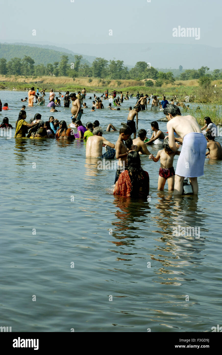 People bathing in holy water of Tansa River on occasion of Tripuri ...