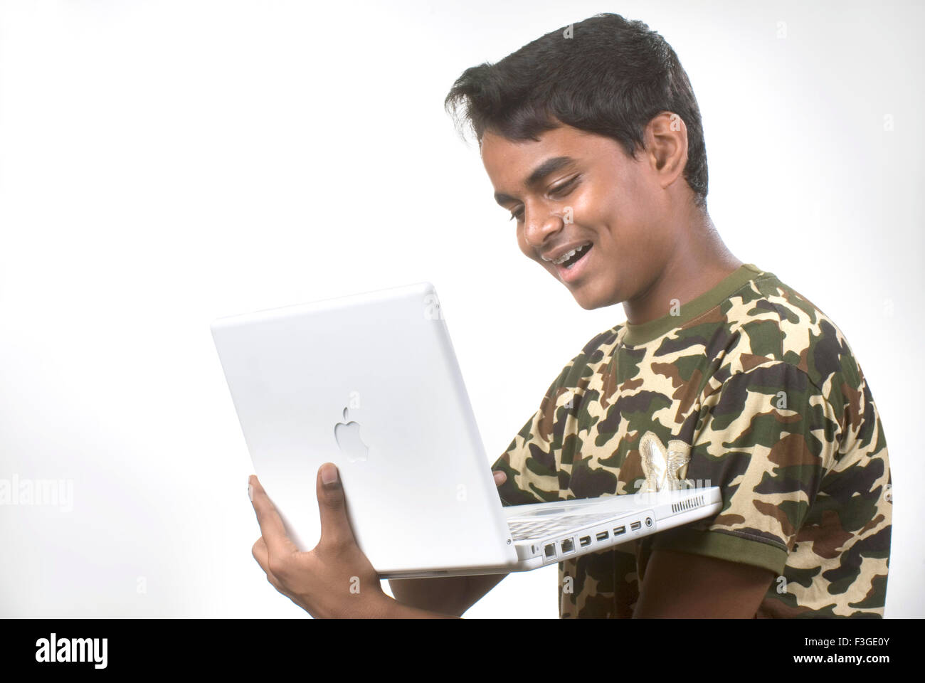 Teenager boy operating laptop MR#733 Stock Photo - Alamy