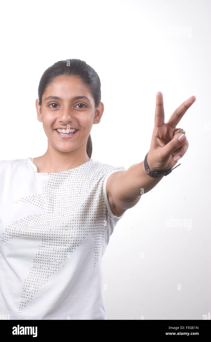 Portrait of teenager girl showing victory sign MR#733 Stock Photo - Alamy