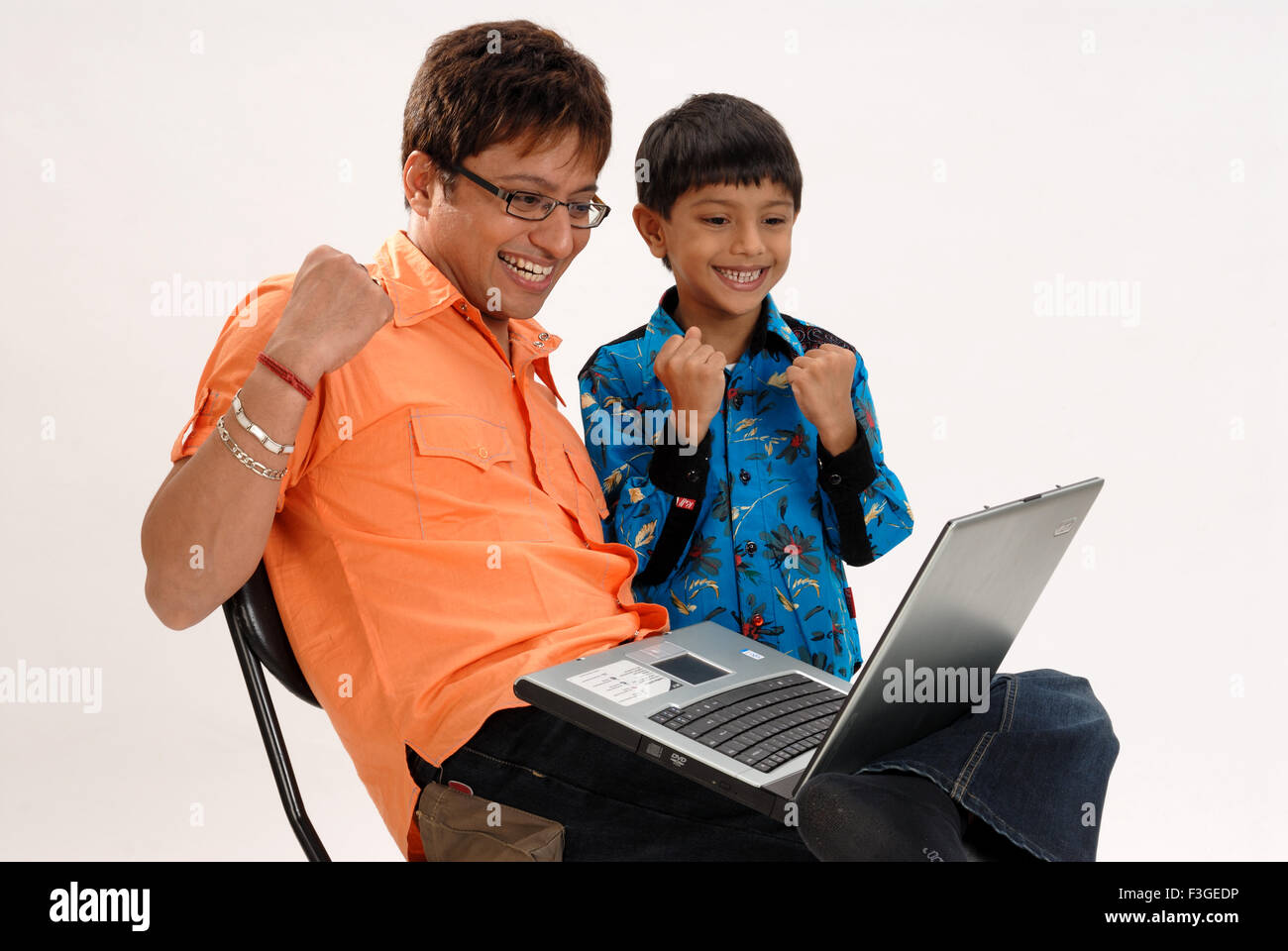 Father and son working on laptop computer fists clenched MR#364 Stock ...