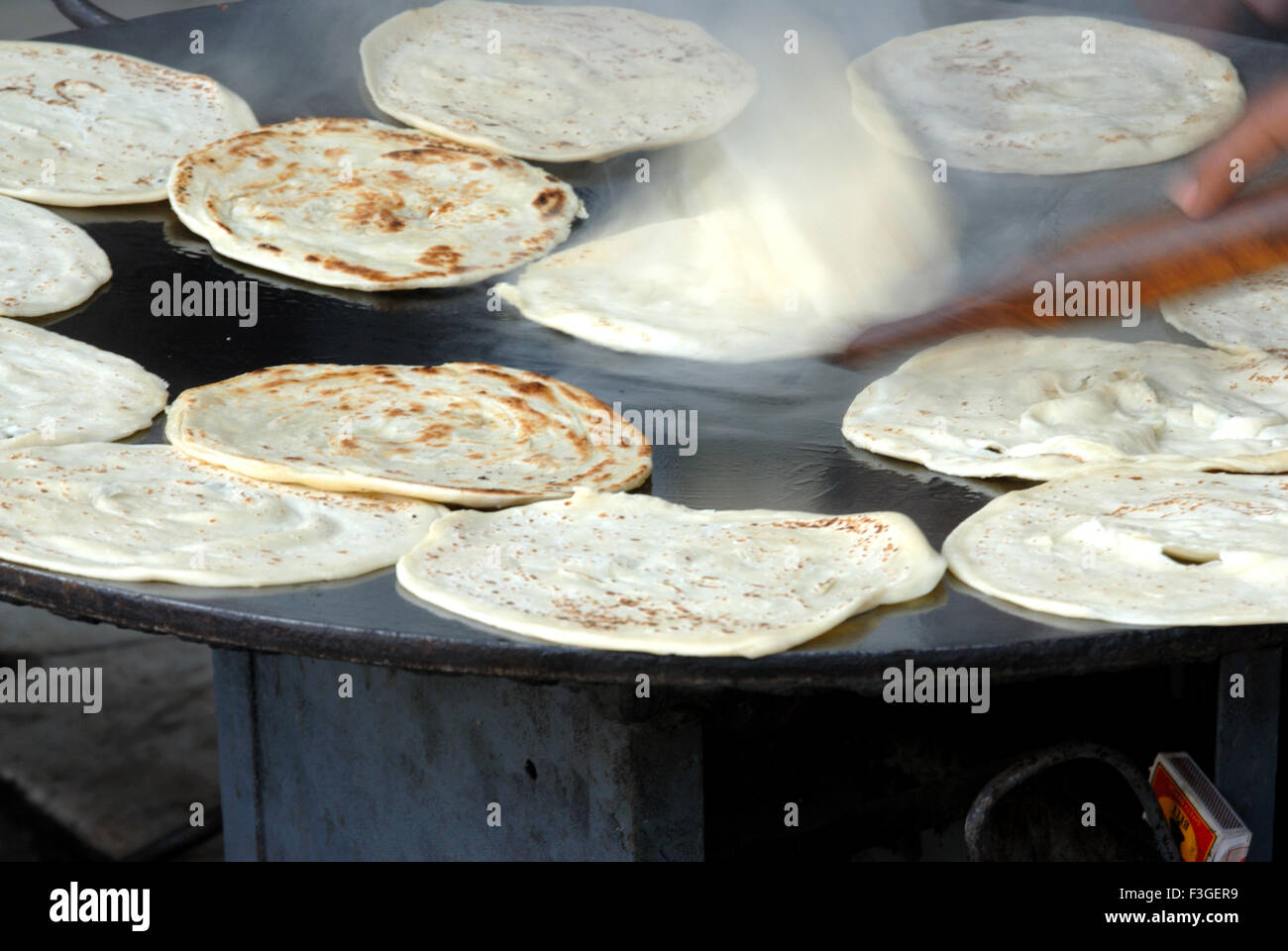Indian food ; roti or chapatti made of maida flour roast on frying pan ...
