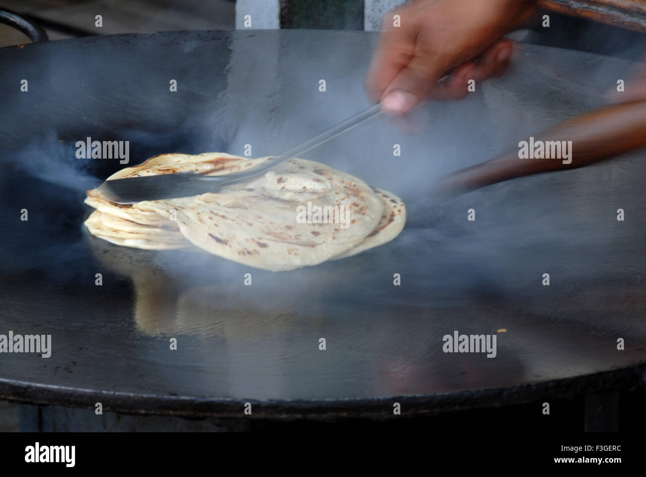 Indian food ; roti or chapatti made of maida flour roast on frying pan ...