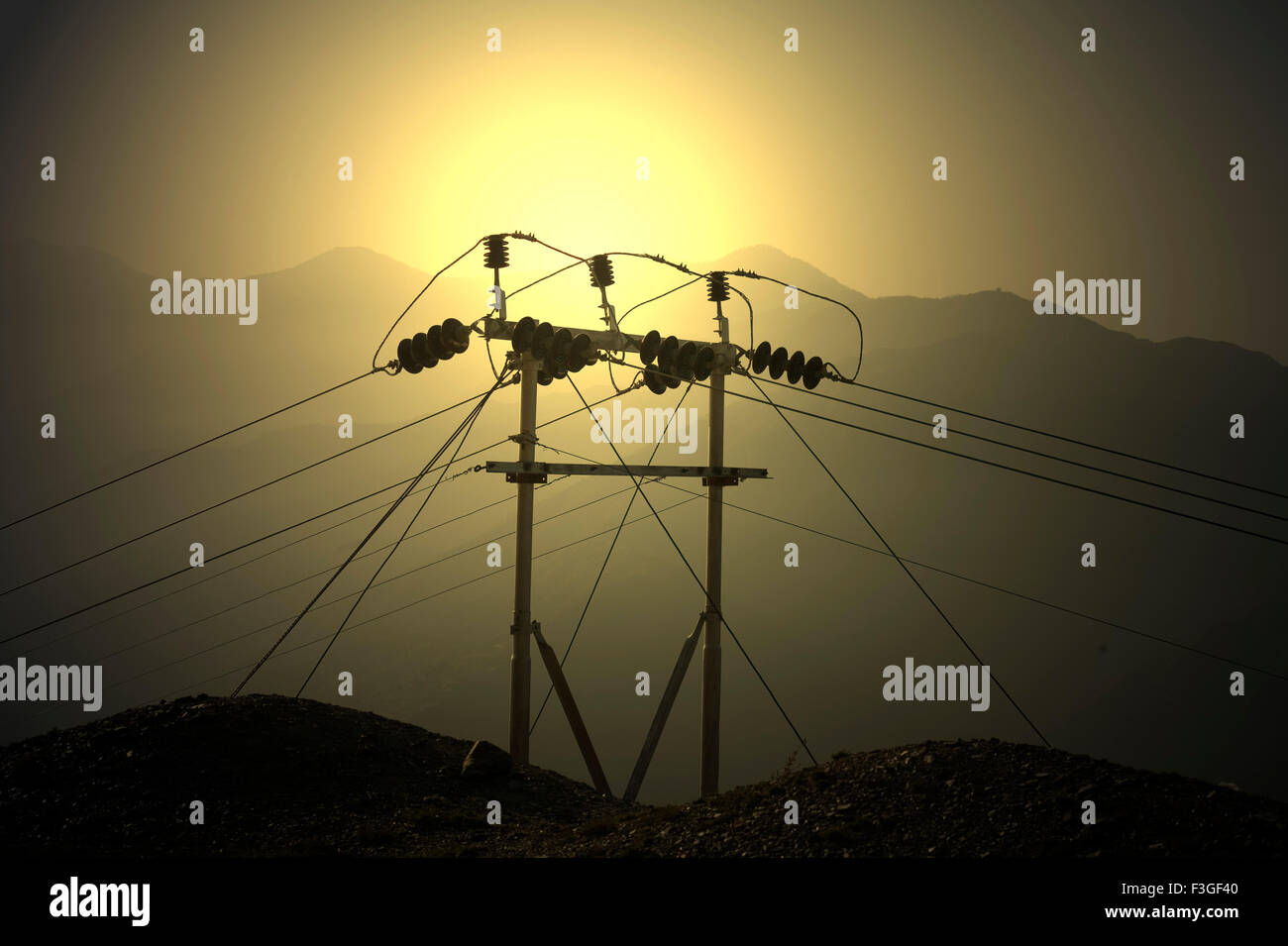 Electric pole with background of sunrise; Himalaya Nagthat ; Uttranchal ...
