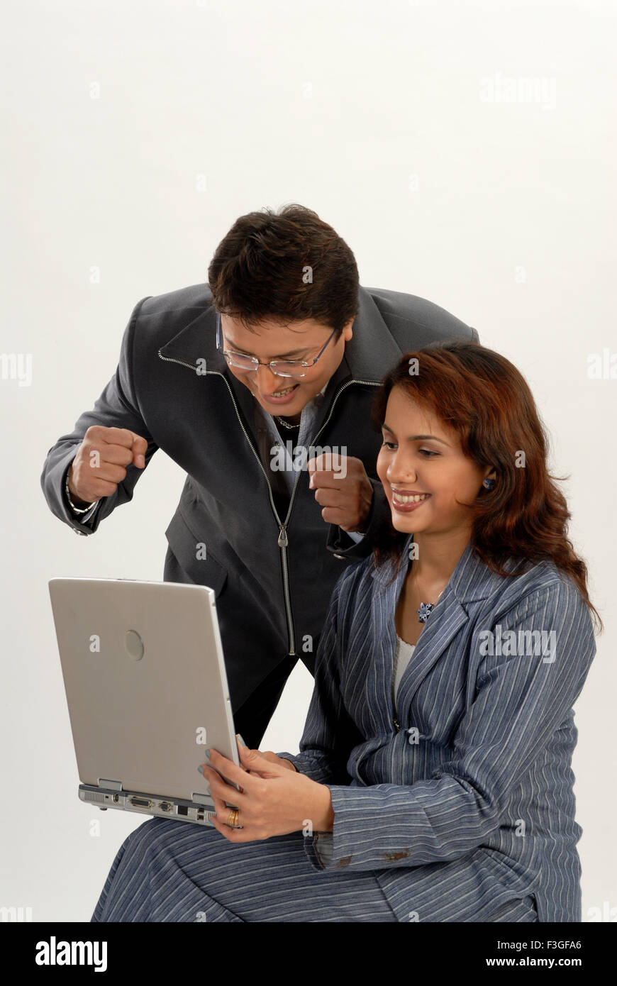 Man excited looking at laptop computer woman working on white ...