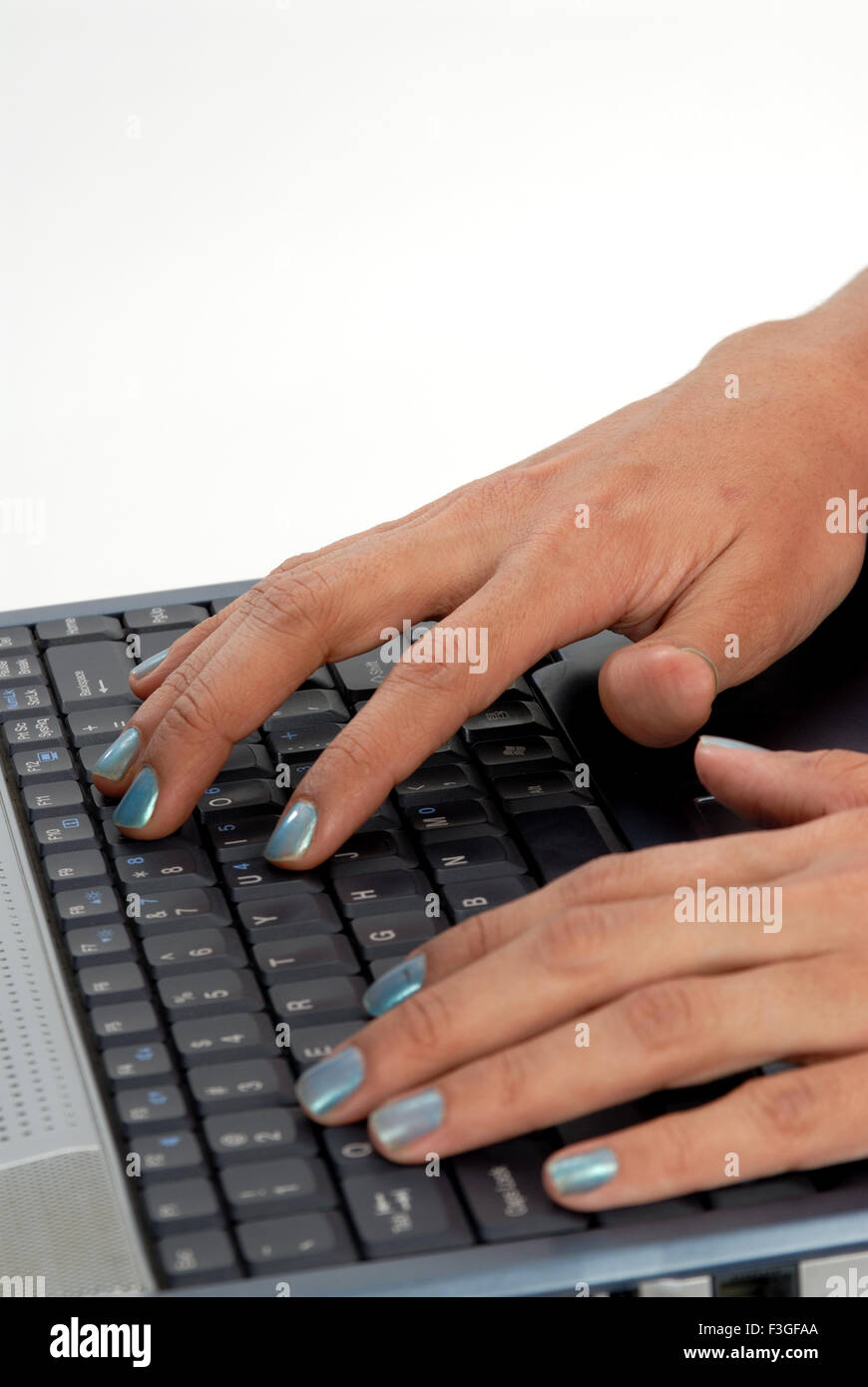 Indian woman blue nail polish working on laptop computer - MR#682M ...