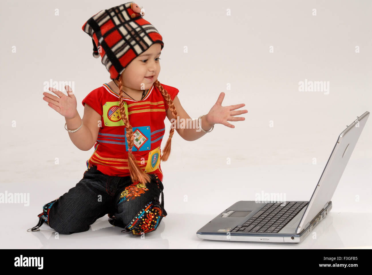South Asian Indian baby learning laptop and enjoying clapping ; Bombay ...
