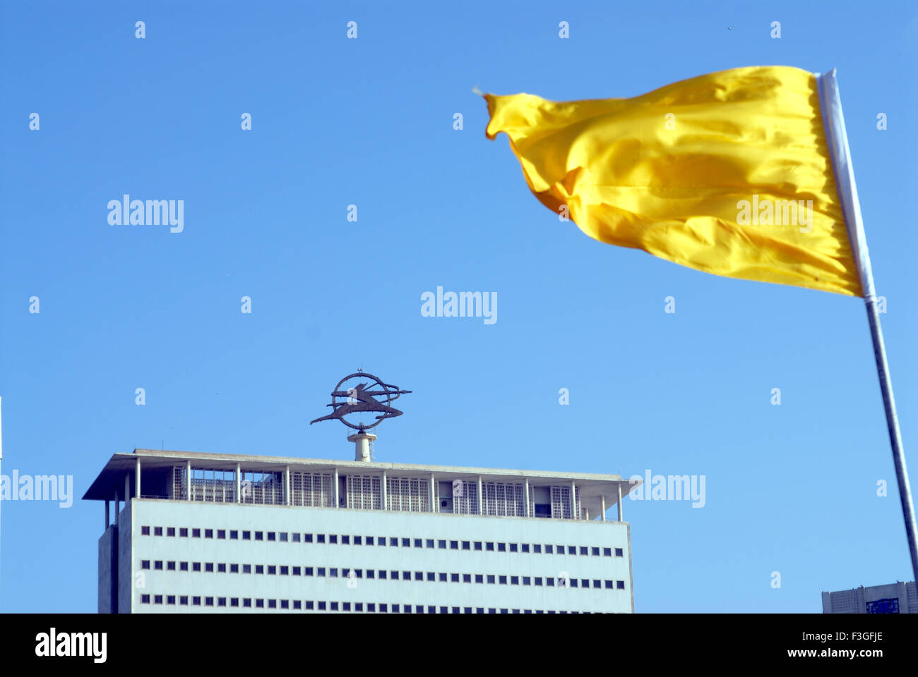 Yellow flag flying in blue sky near Air India building ; Bombay Mumbai ...