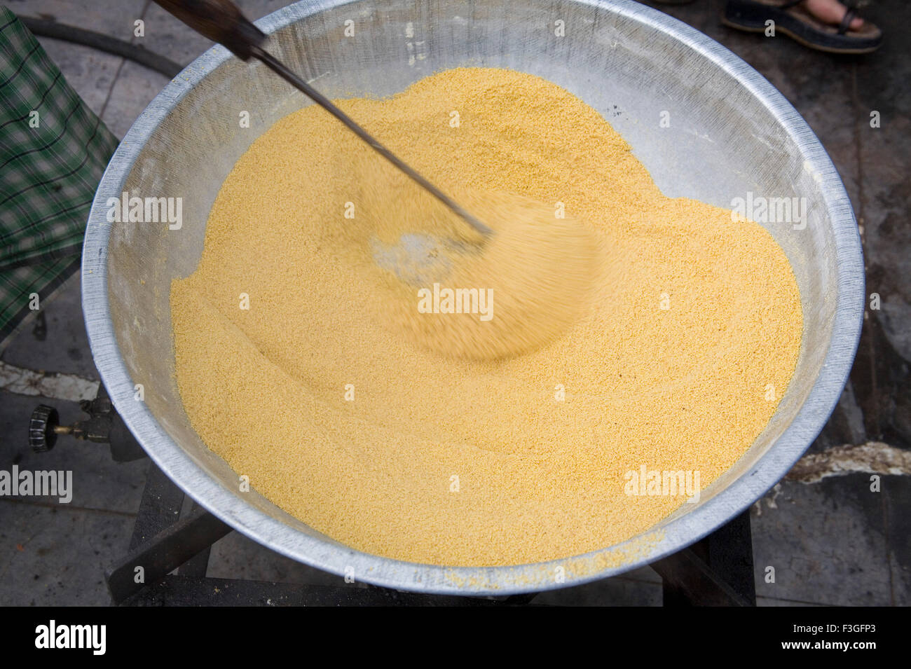 Cooking ; Frying Gram flour for making Litties a kind of bread ...