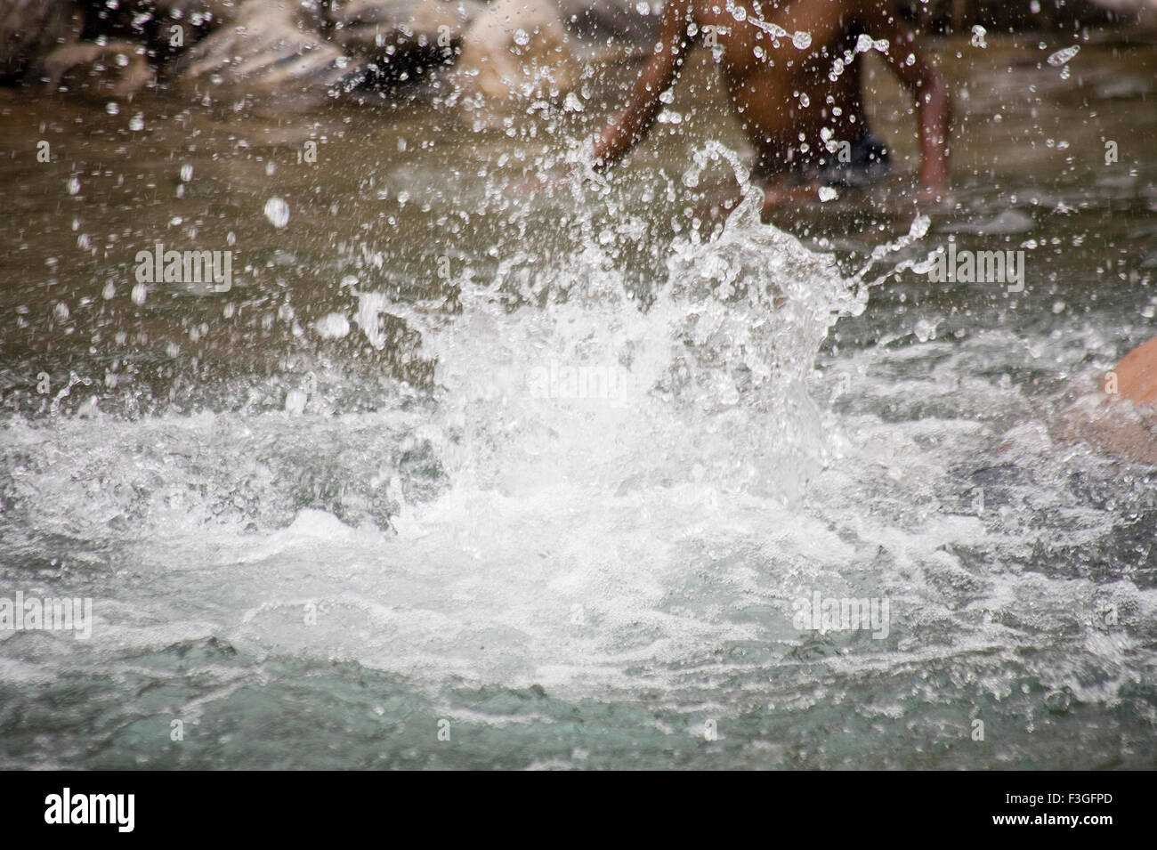 Natural spring splash in flowing water ; foothills of Himalaya ...