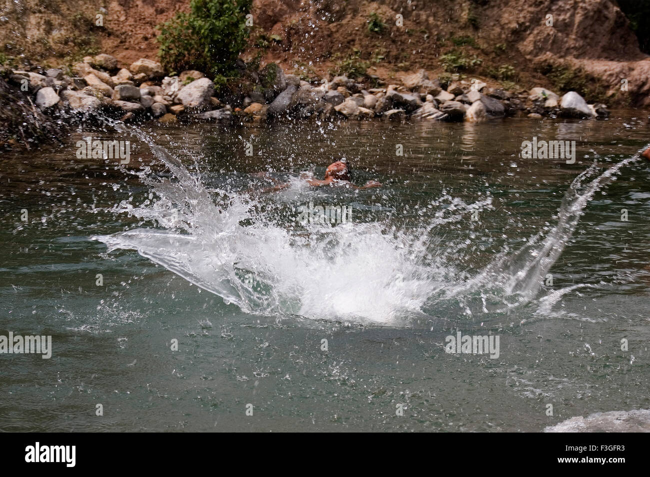 Natural spring splash in flowing water ; foothills of Himalaya ...