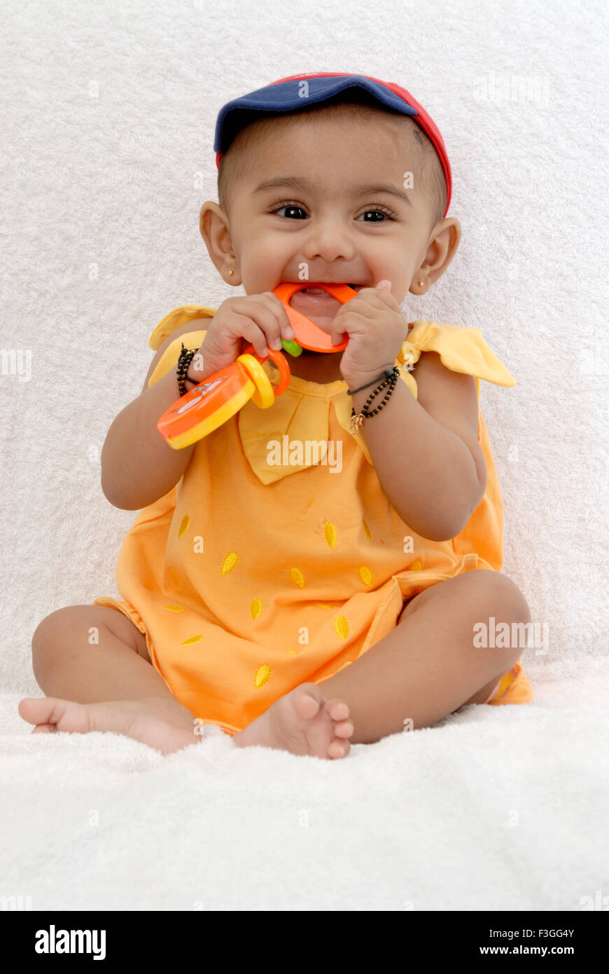 Baby biting chewing plastic toy on white background MR#152 Stock Photo ...