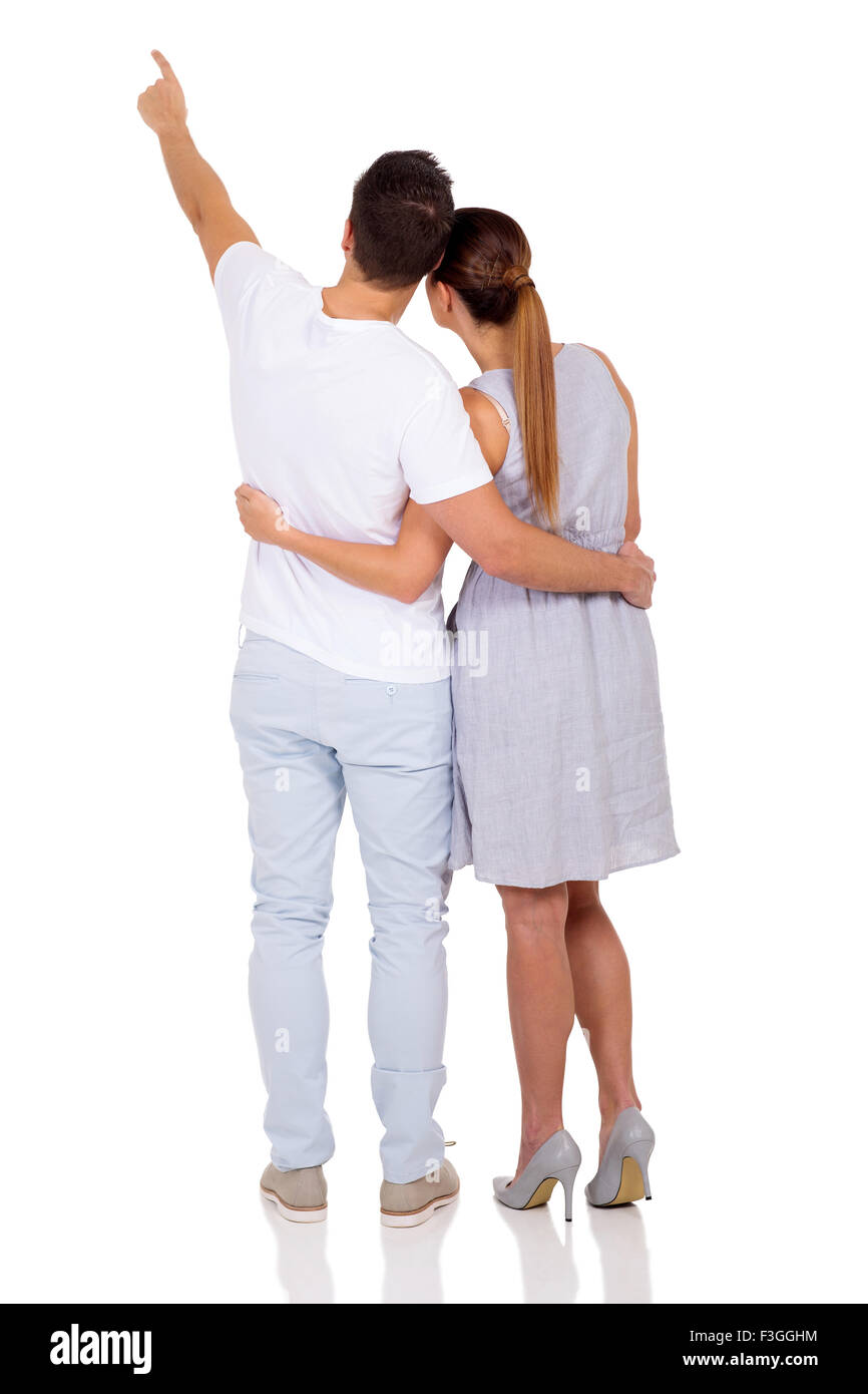 rear view of married couple pointing on white background Stock Photo ...