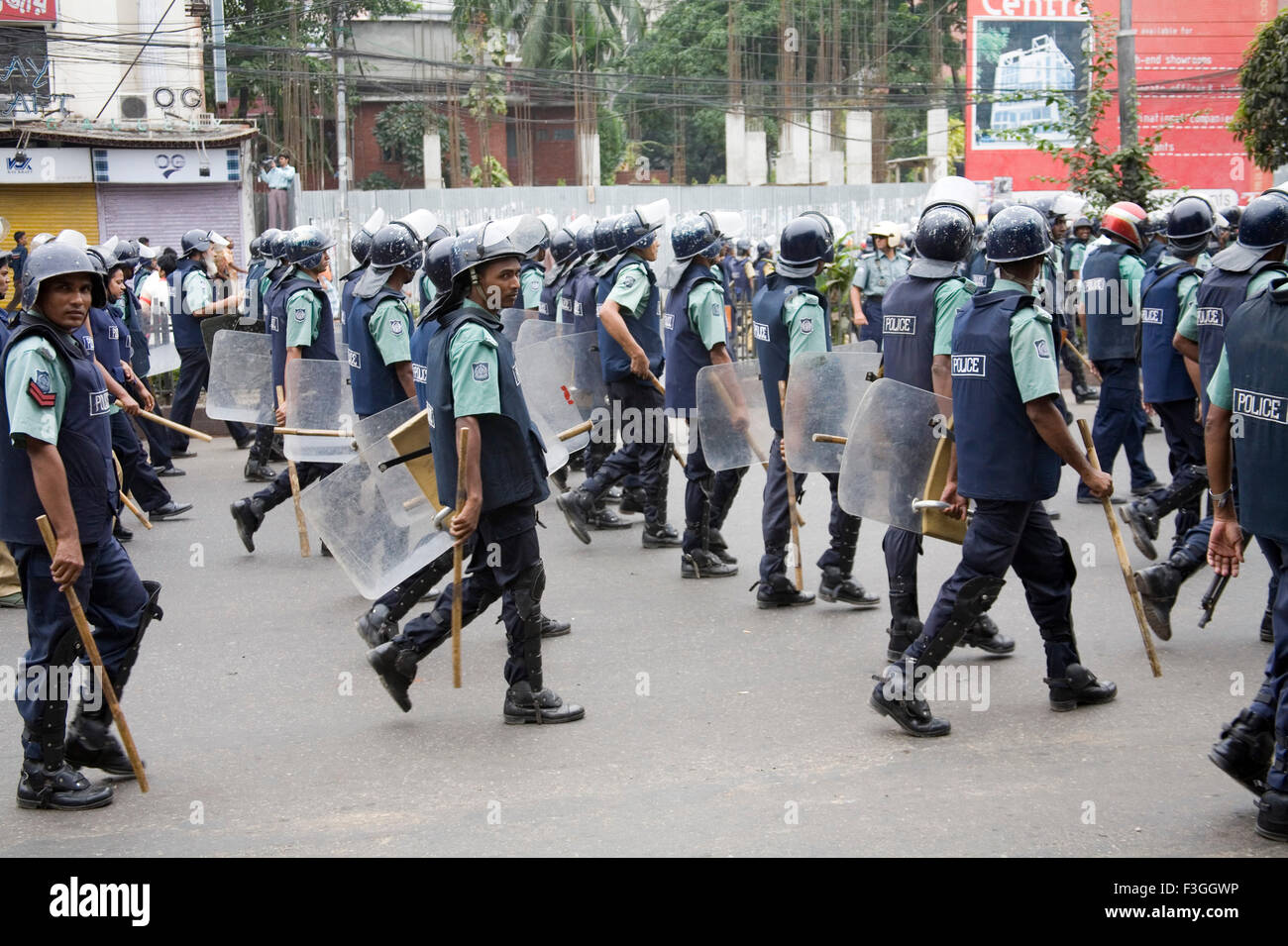 Police wearing blue uniform marching stick hands road to control the ...