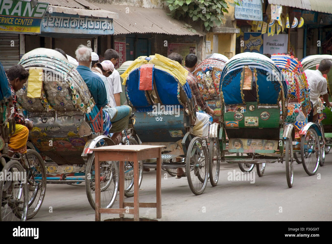 Cycle rickshaws parked on road ; Dhaka ; Bangladesh Stock Photo - Alamy