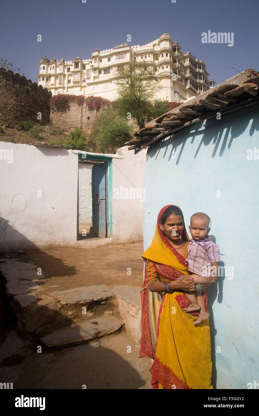 Indian woman standing with her son at her home near Devigadh palace ...