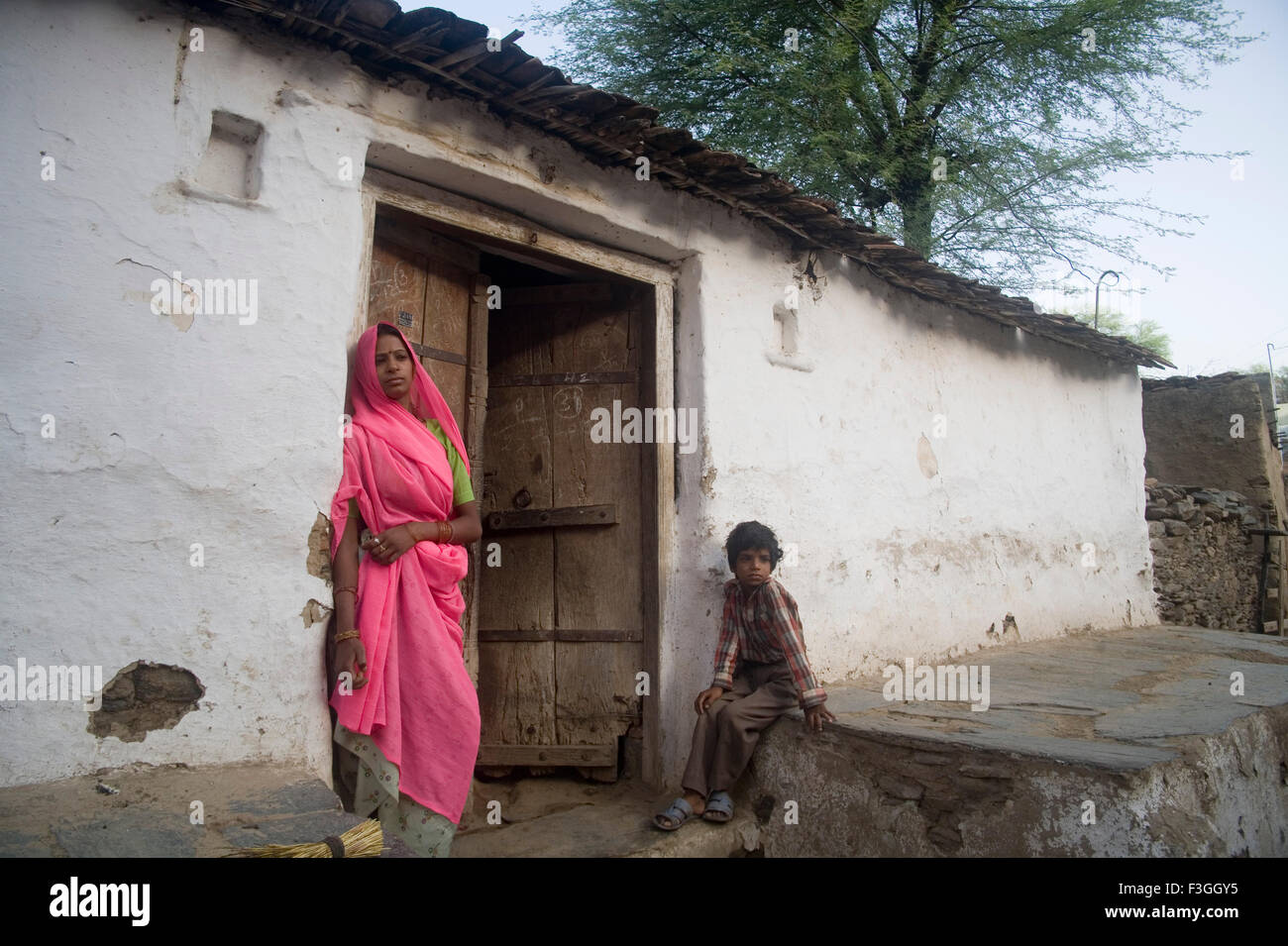 Woman standing with her son ; Village Delwada ; Udaipur ; Rajasthan ...