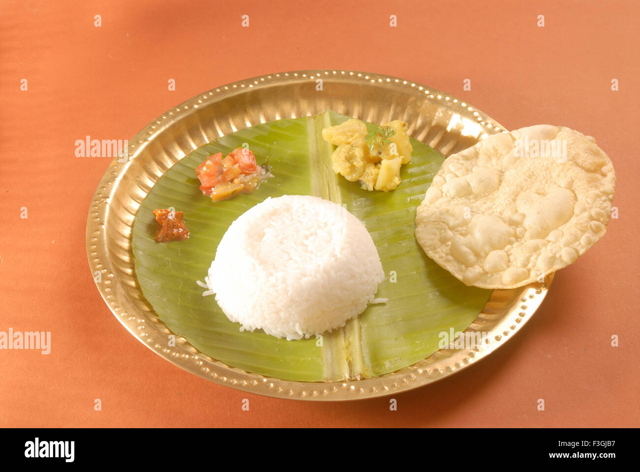 Vegetarian ; Indian food varan bhat rice pickles and puri on banana ...