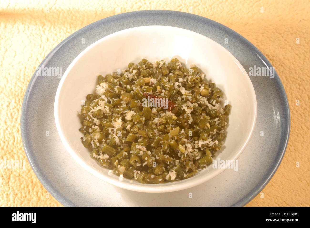 Vegetarian ; Indian food Beans Upkari in round white ceramic plate ...