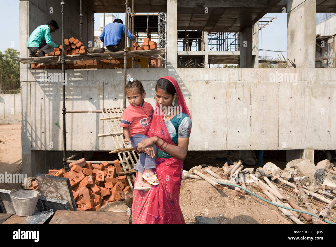 Working mother at a construction site with her child Ahmedabad ...
