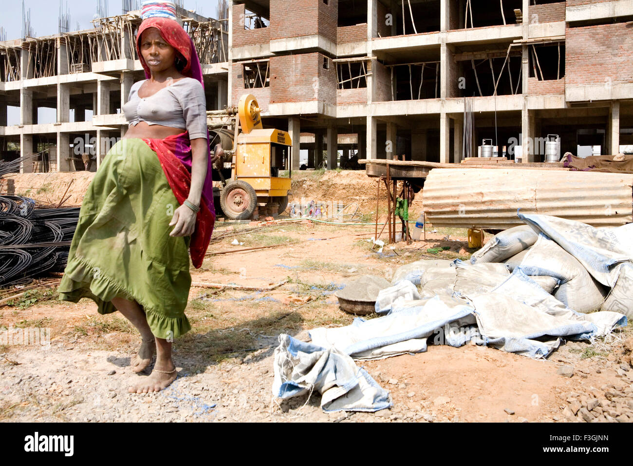 Pregnant women worker at construction site with her hands and legs ...