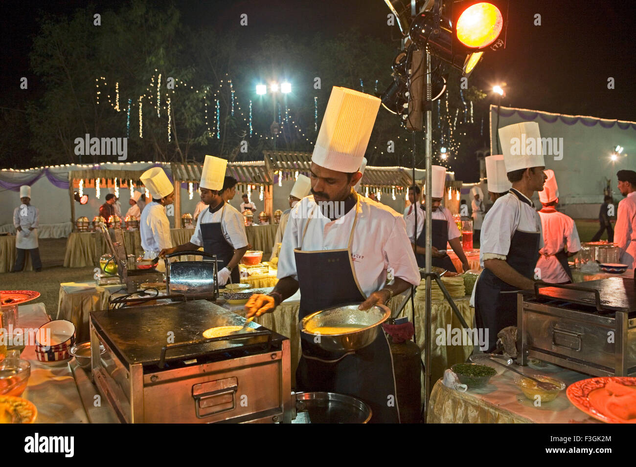 Chefs busy in preparing food for guests at Indian wedding ; Bombay ...