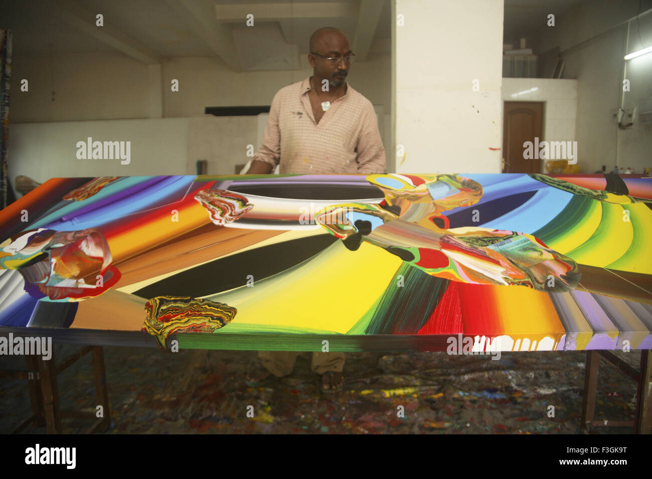 Indian contemporary artist Bose Krishnamachari in his studio working on ...