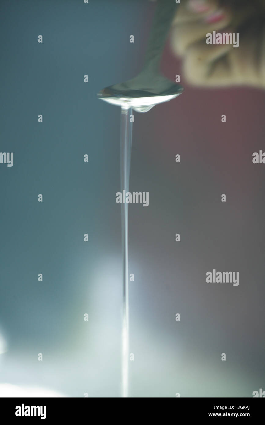 Water dripping from spoon Stock Photo - Alamy