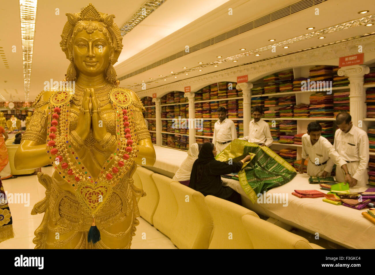 Interior of shopping mall with statue of woman part of decoration to ...
