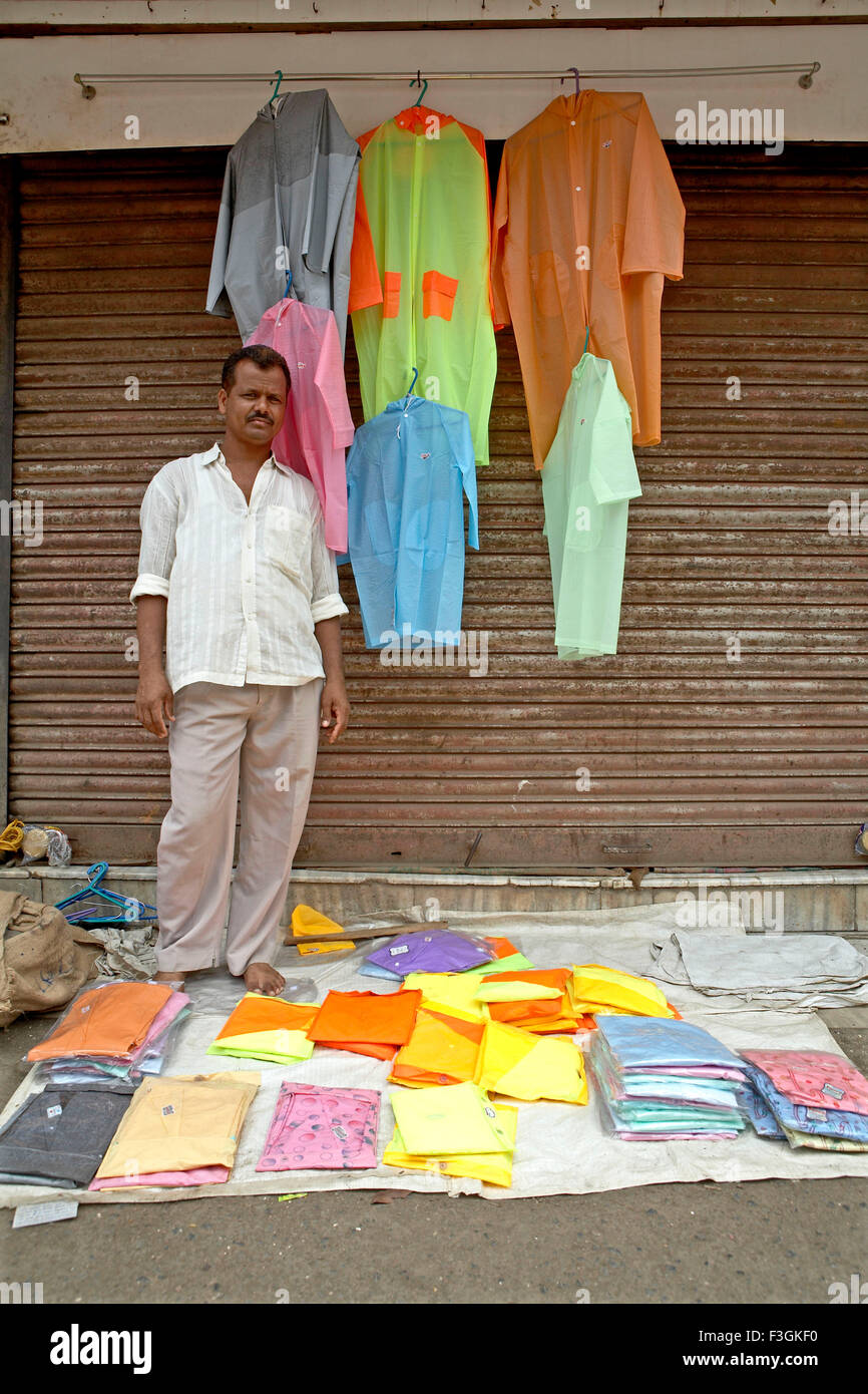 Seasonal display of raincoats on the shutters of a closed shop ; Mumbai ...