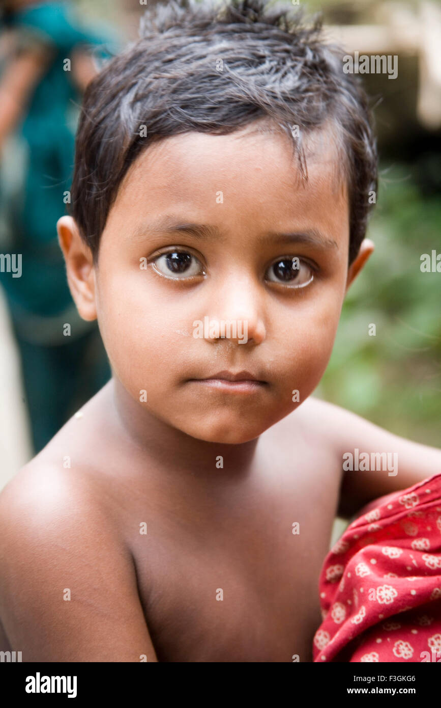 South Asian Indian Poor boy looking at camera ; village Manik gunj ...