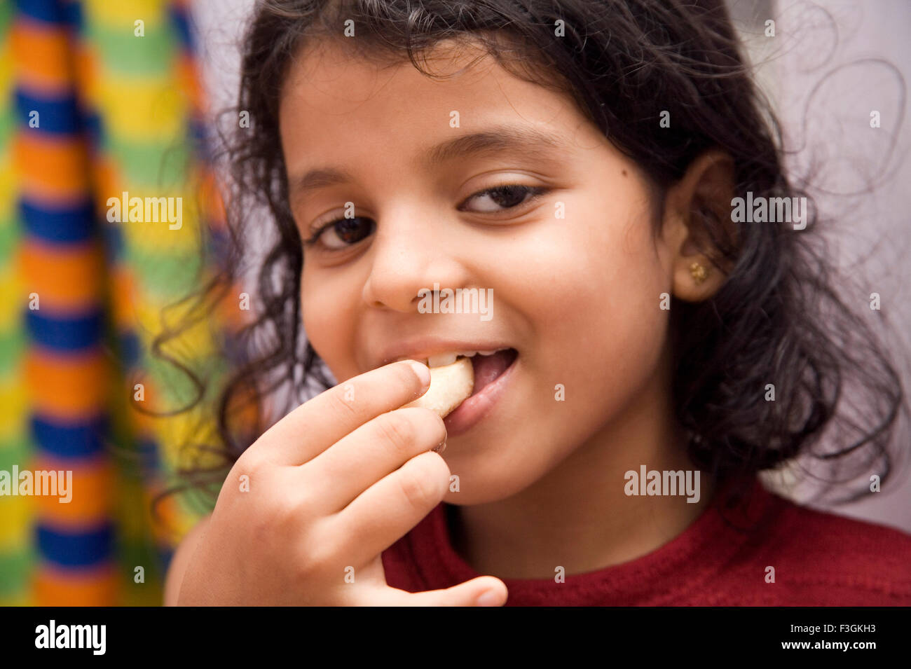 South Asian Indian Girl Sanchi eating cookies ; Mumbai Bombay ...