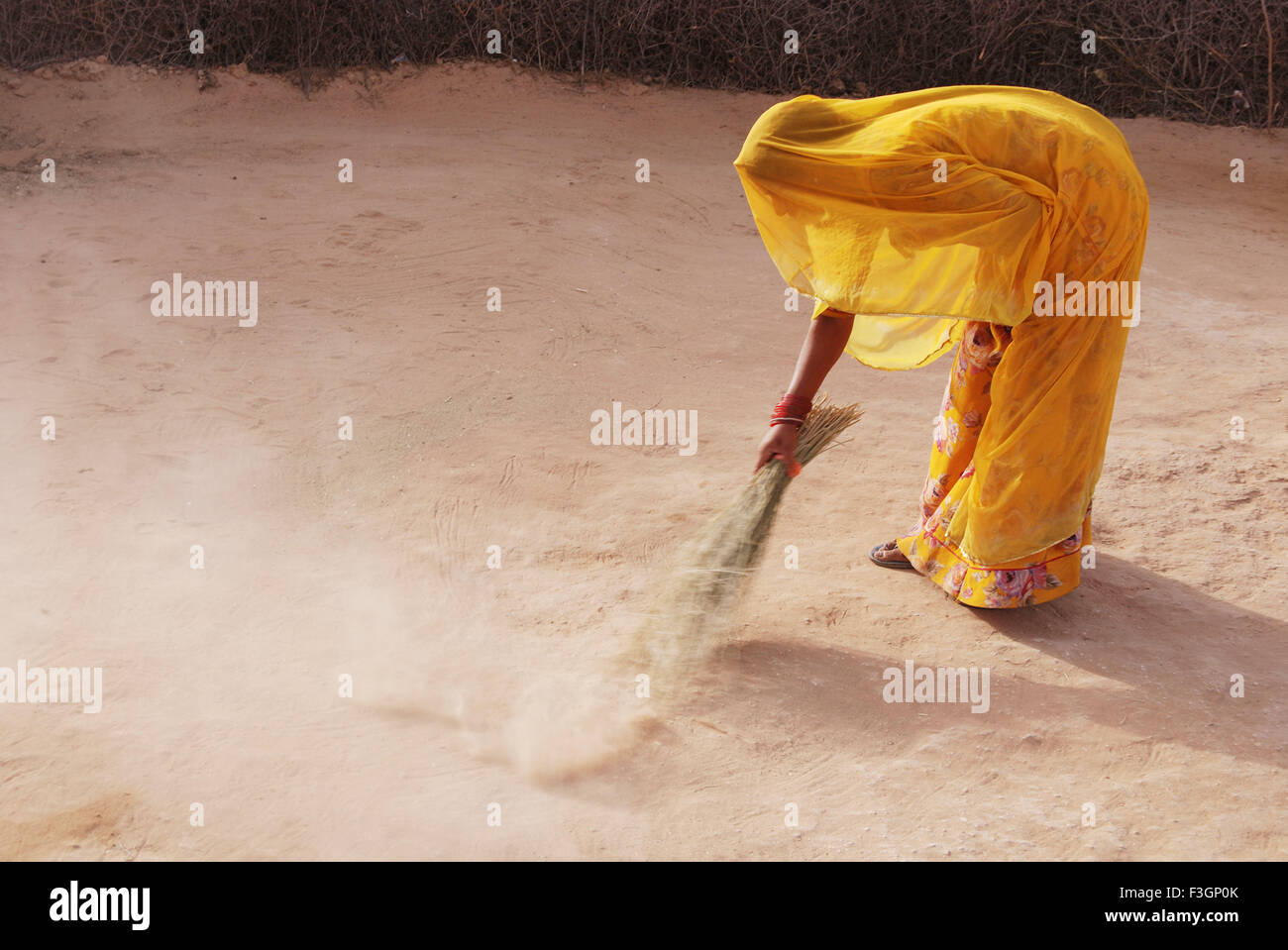 Woman cleaning hut ; Bikaner ; Rajasthan ; India Stock Photo - Alamy