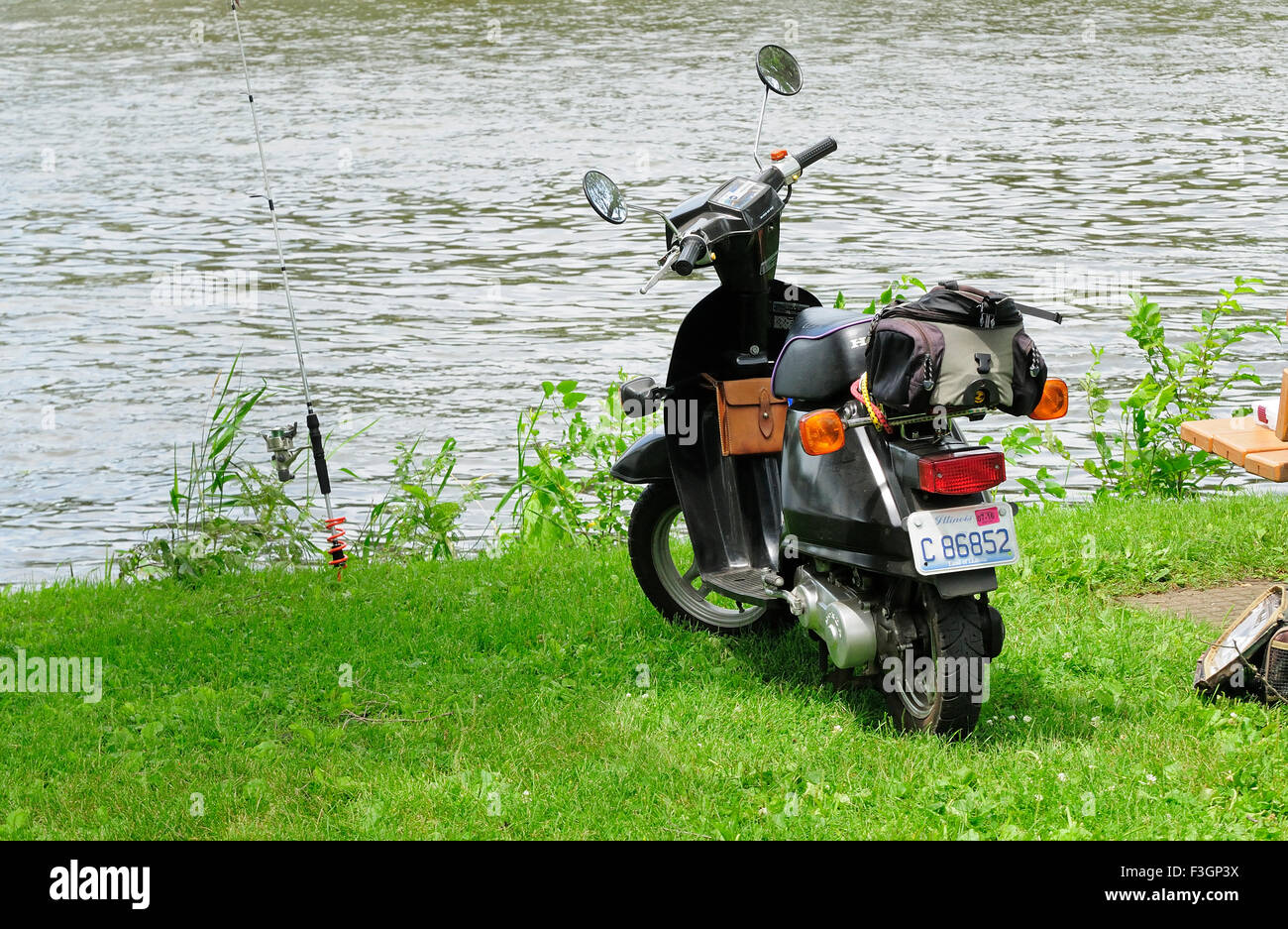 Honda Spree Scooter by river while fishing Stock Photo - Alamy