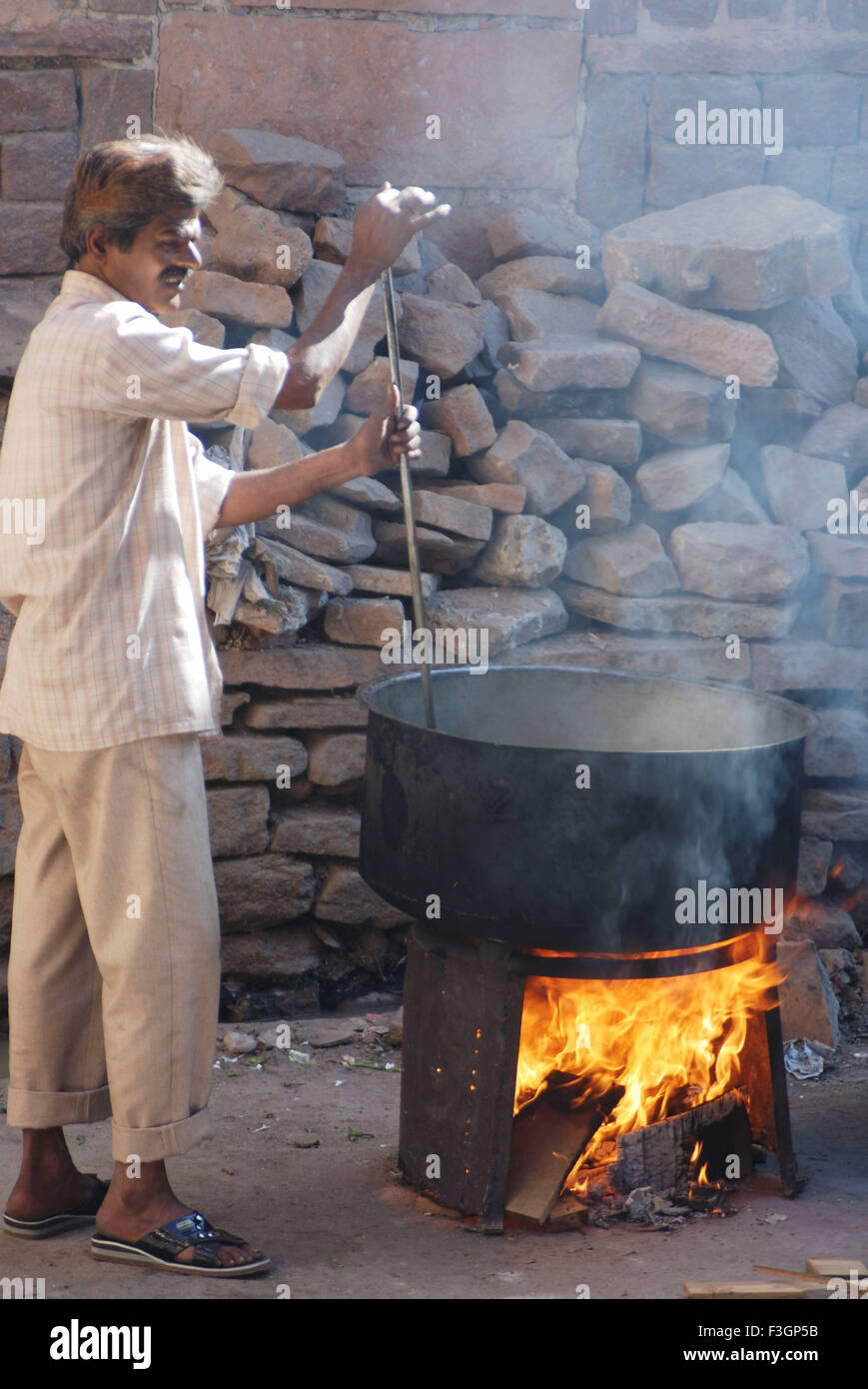 Man frying something on furnace ; Jodhpur ; Rajasthan ; India Stock ...