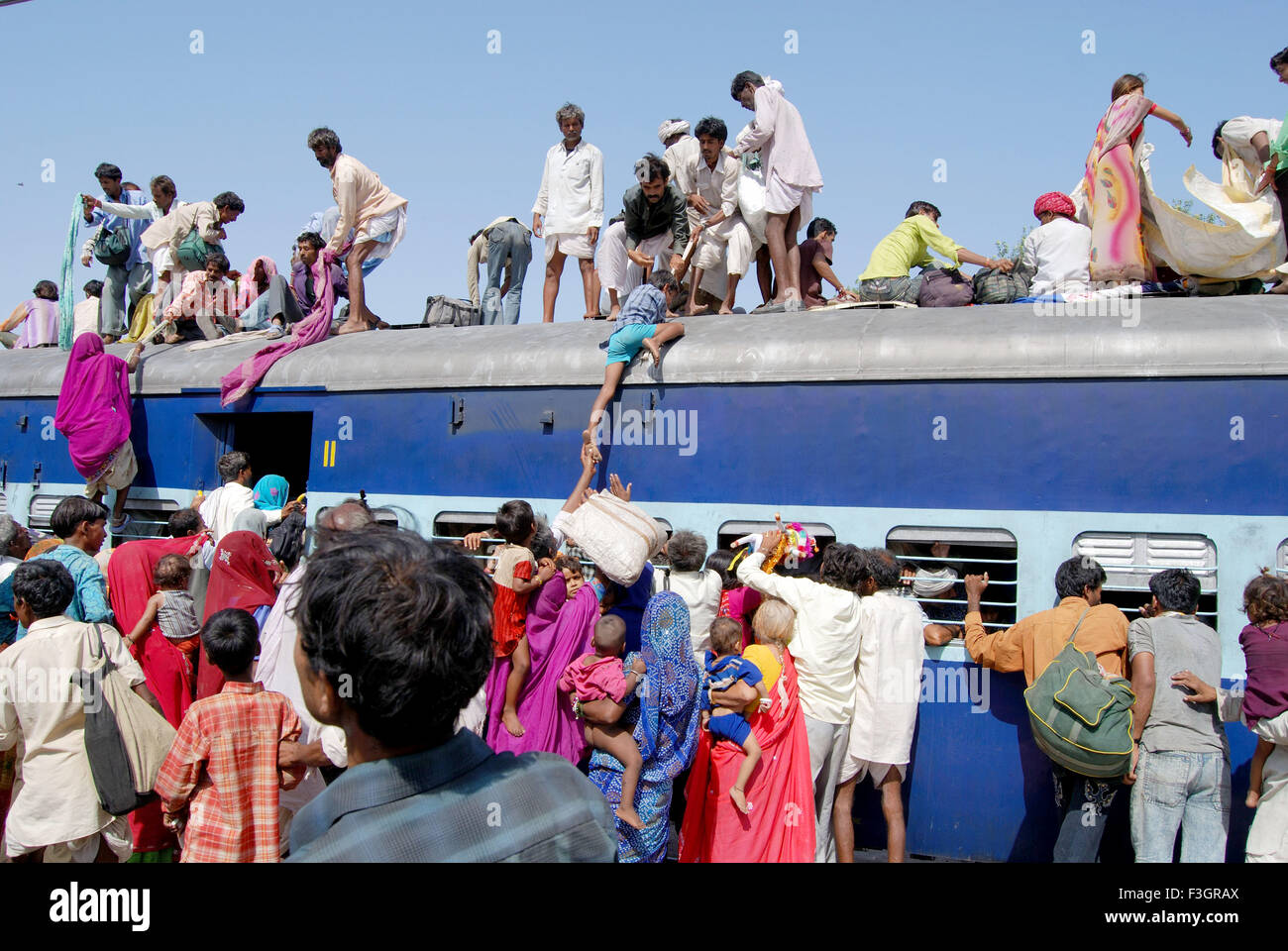 People dragging children and women trying to climb on roof of train on ...