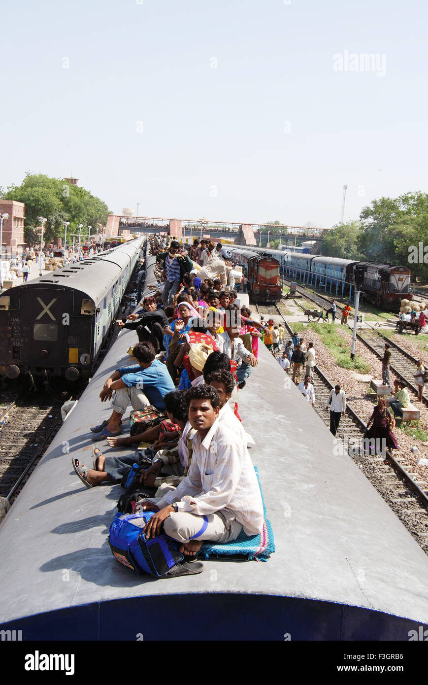 People sitting on roof of train on railway station ; Jodhpur ...