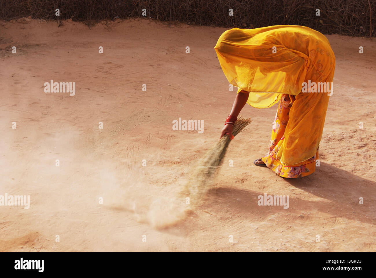 Indian woman in ghunghat sweeping floor with broom, Jodhpur, Rajasthan ...