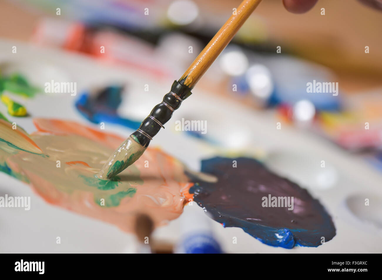 Artist's hand applying paint gouache on the drawing sheet Stock Photo ...