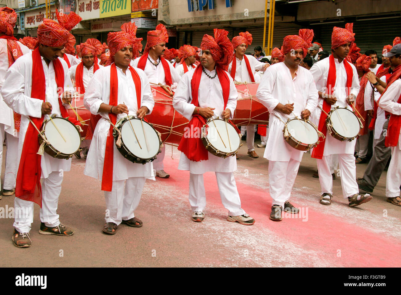 men wearing kurta pajamas red headgear feta playing musical instrument ...