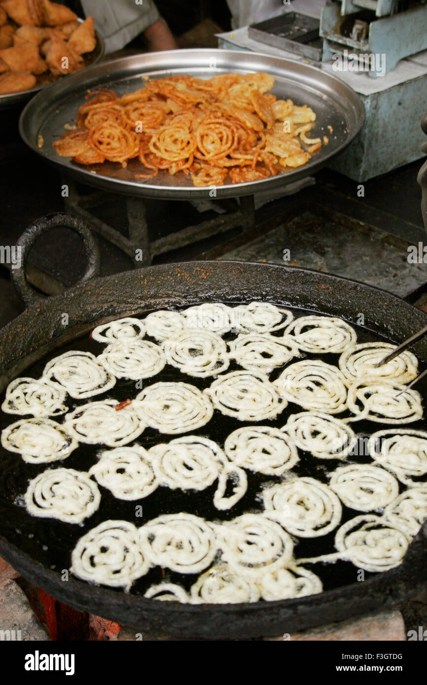 Indian sweet mithai called Jalebis and fried in oil in circular form ...