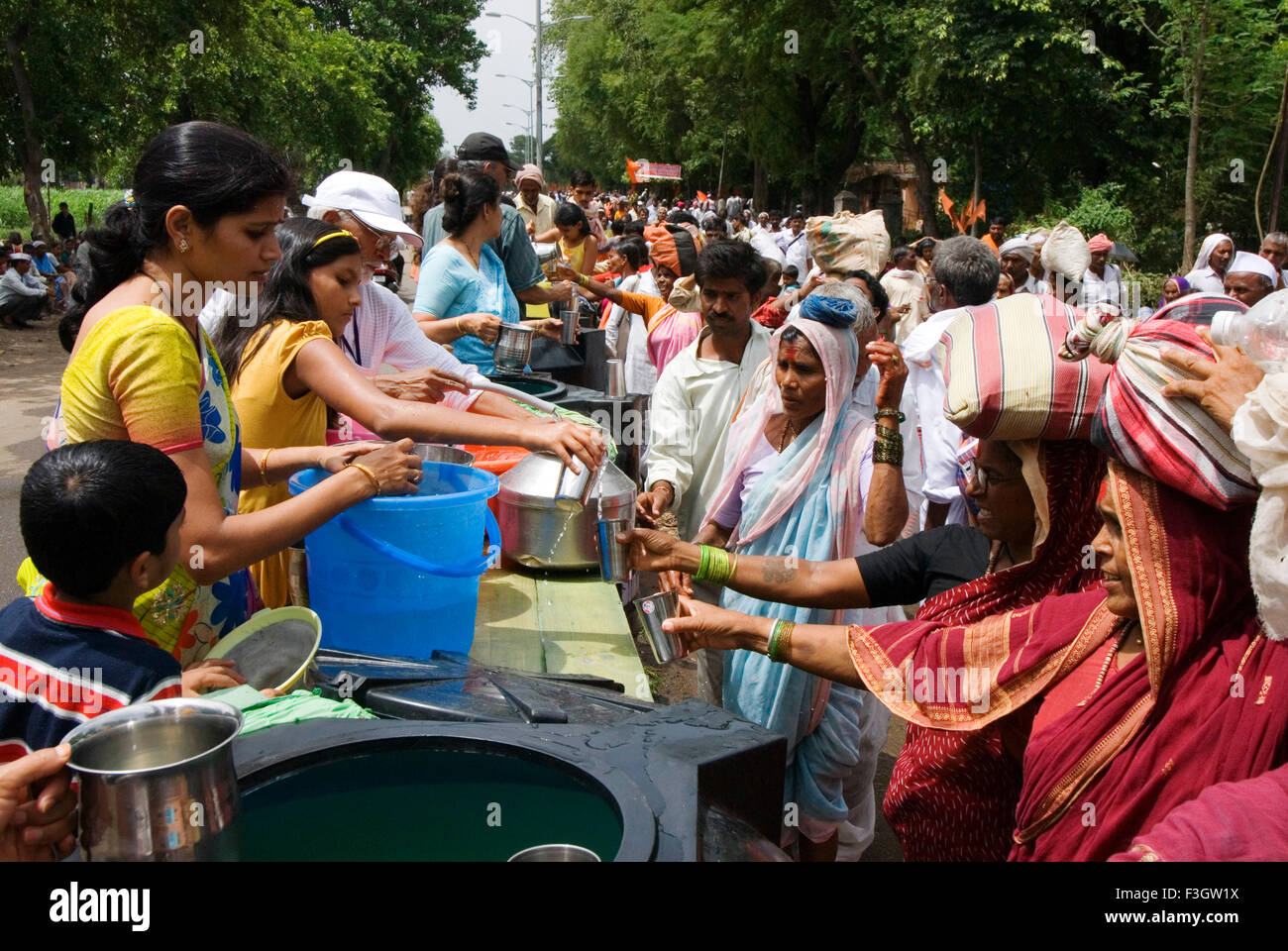 Charity people from city giving water to vari pilgrim at Pune Stock ...
