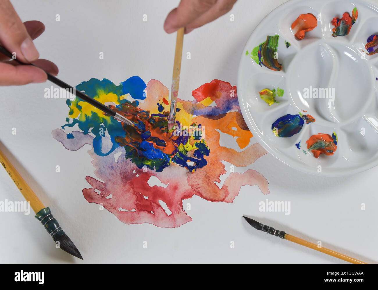 Artist's hand applying paint gouache on the drawing sheet Stock Photo ...