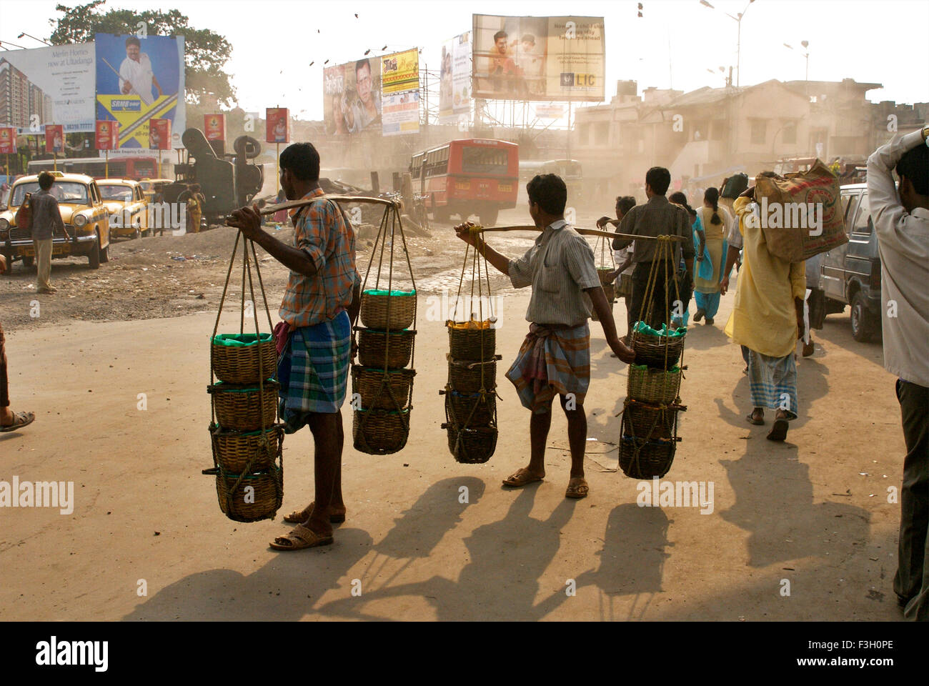Male labourers carrying load on their shoulders ; Howrah ; Calcutta ...