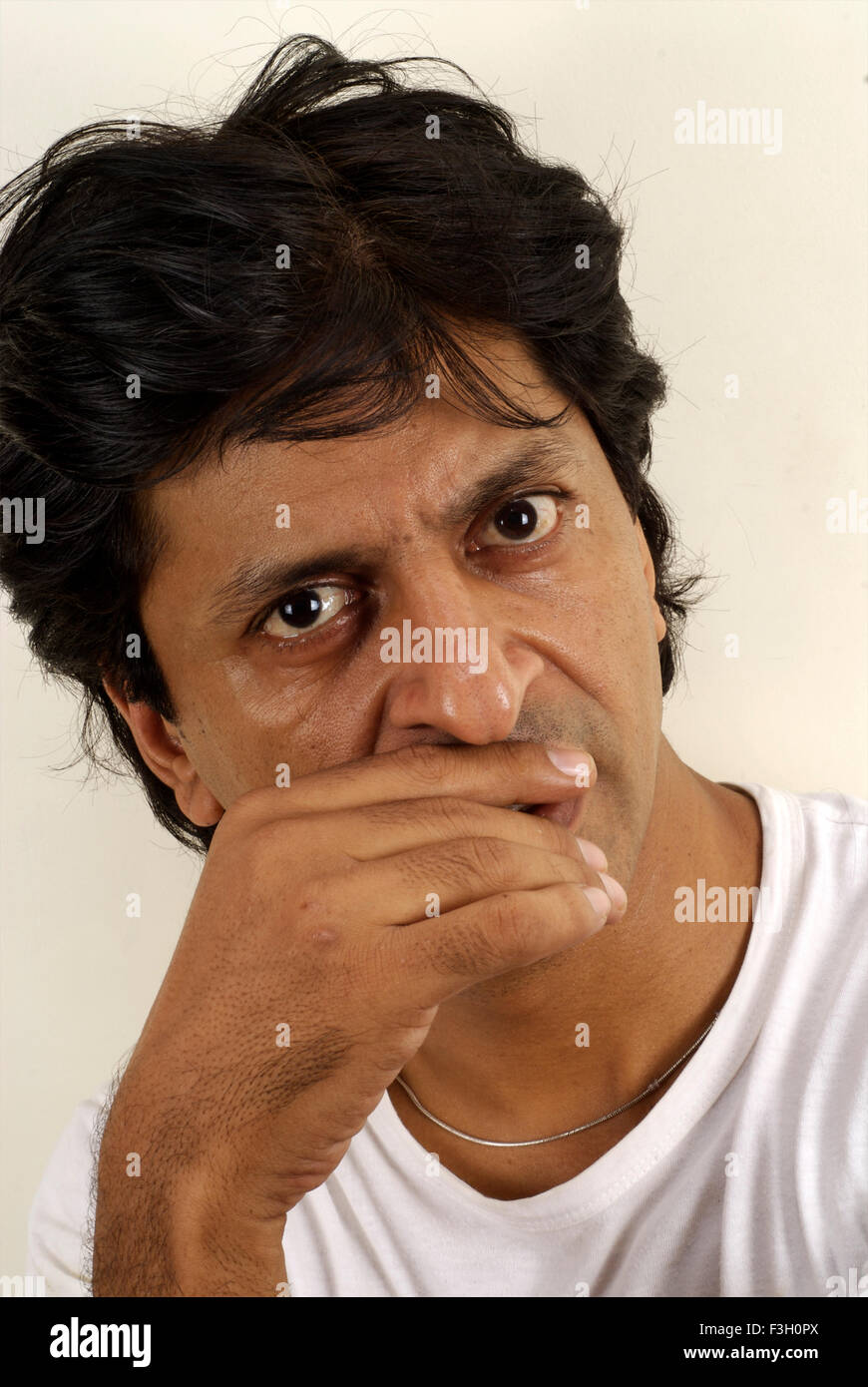 South Asian Indian man Alok Ulfat looking at camera in suspicion ...