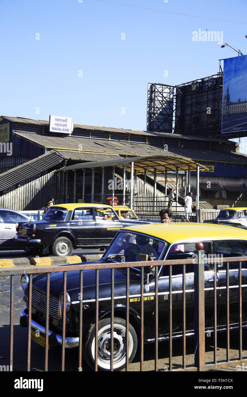 Mahalakshmi railway station & traffic on the road ; Bombay now Mumbai ...