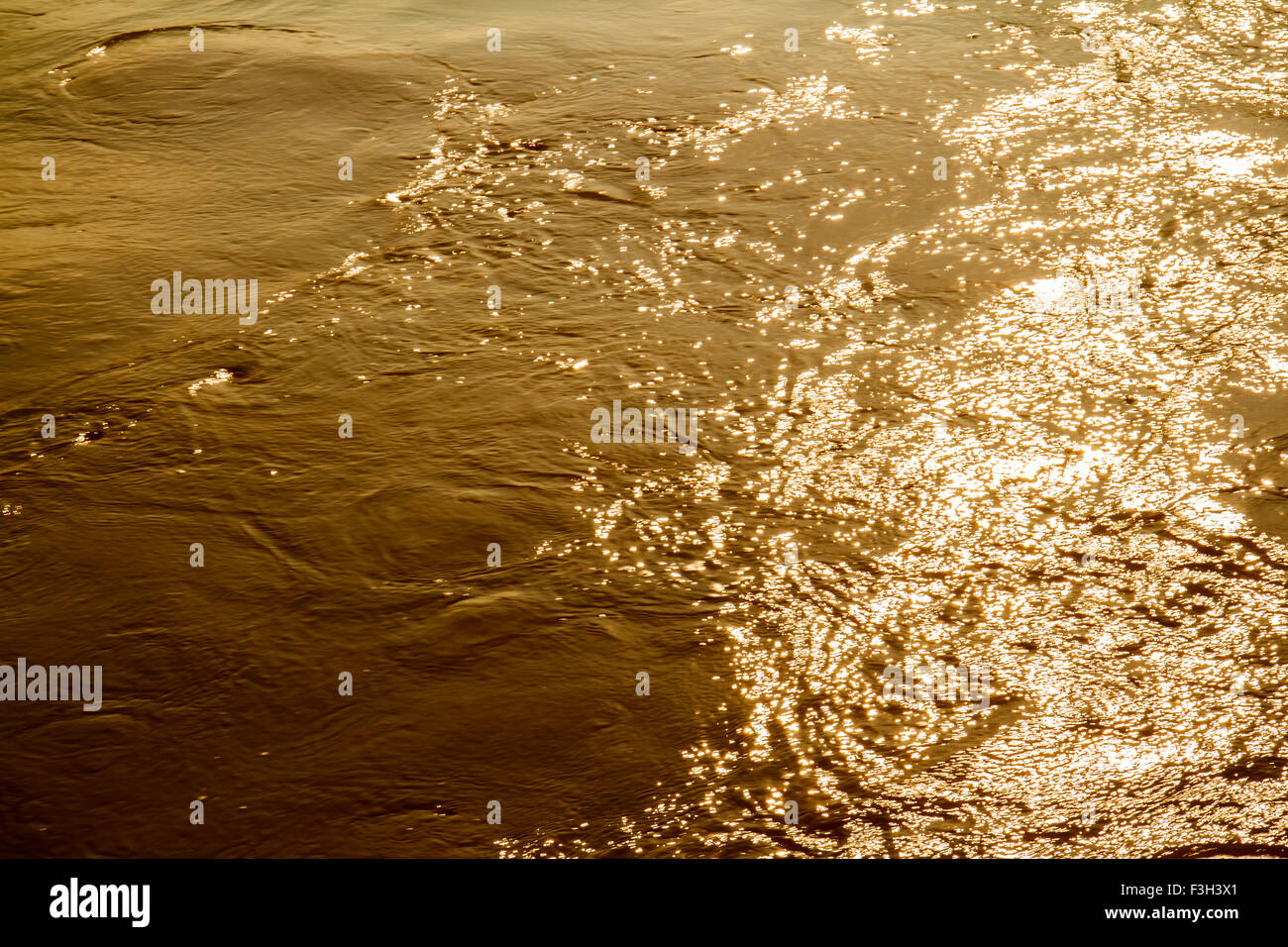 Sun reflected in water Stock Photo - Alamy